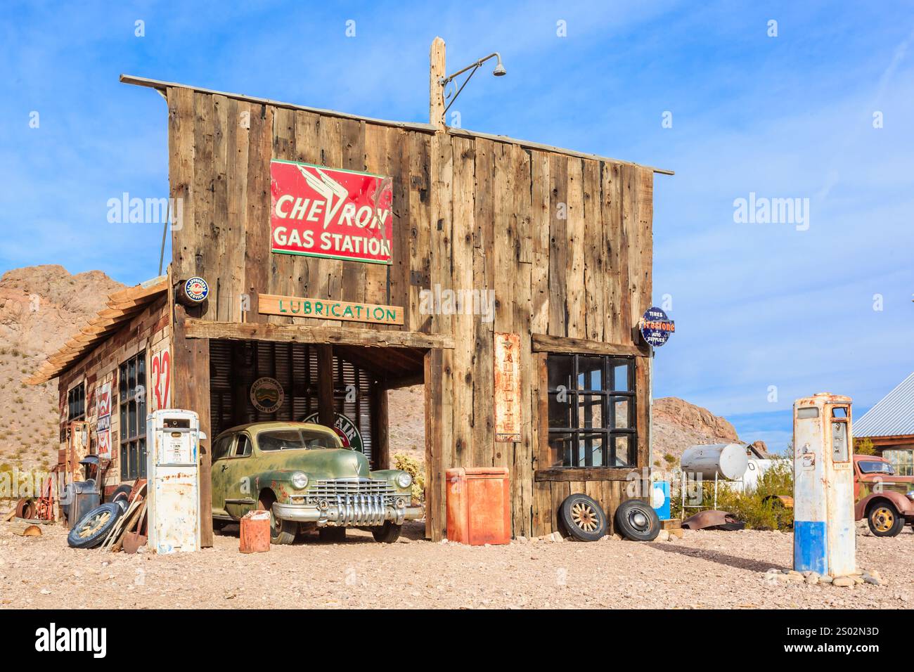 A gas station with a Chevron sign on the side. The building is old and ...