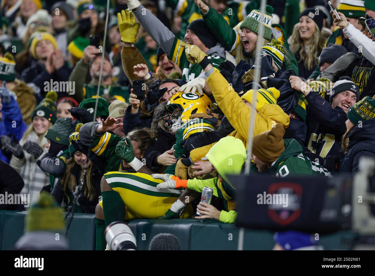 Green Bay Packers running back Emanuel Wilson (31) leaps into the crowd ...
