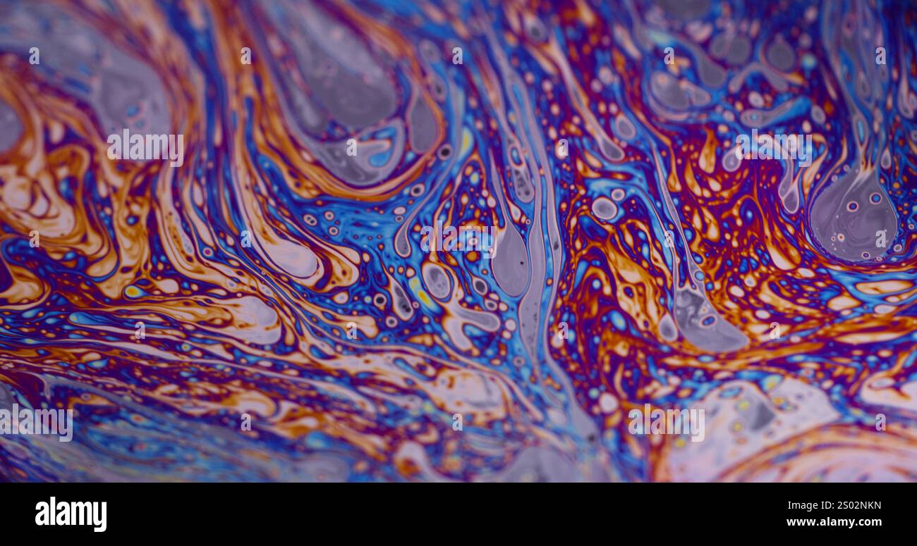Vivid rainbow color. Swirls soap bubble. Defocused purple green liquid ...