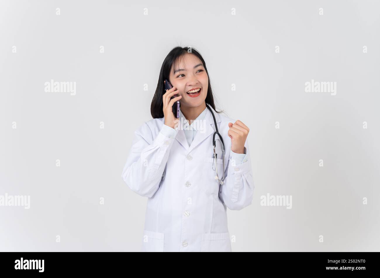 A positive Asian female doctor in a white gown uniform showing a ...