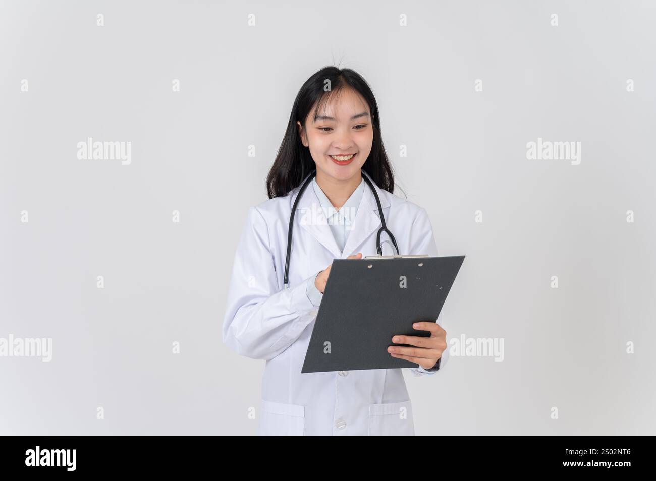 A beautiful Asian female doctor in a uniform checking medical cases on ...