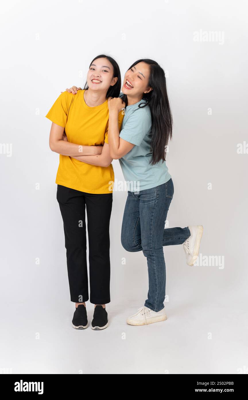 A full-body image of two lovely, cheerful Asian female best friends in ...