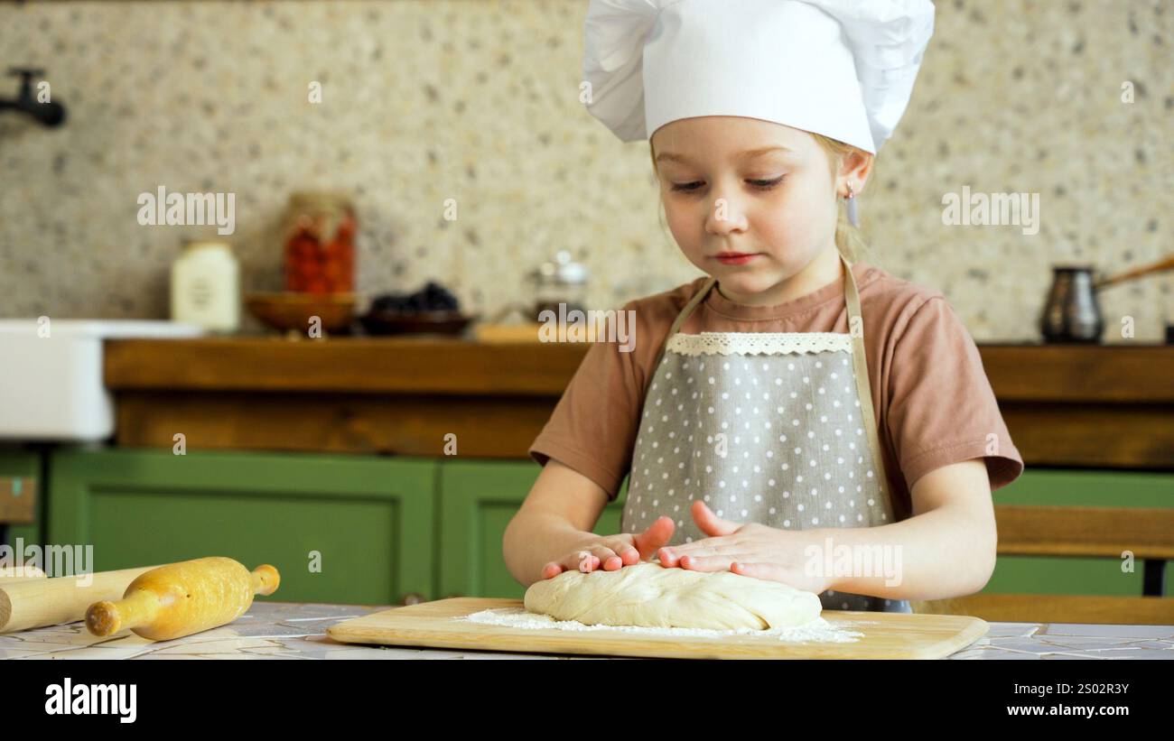 Little baker making dough in the kitchen Stock Photo - Alamy