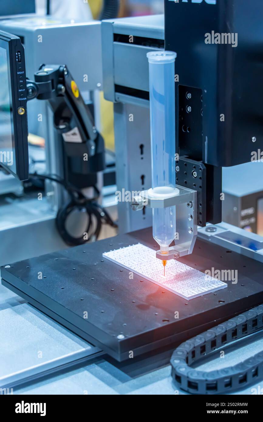 automatic holding glue syringe Injection in factory Stock Photo - Alamy