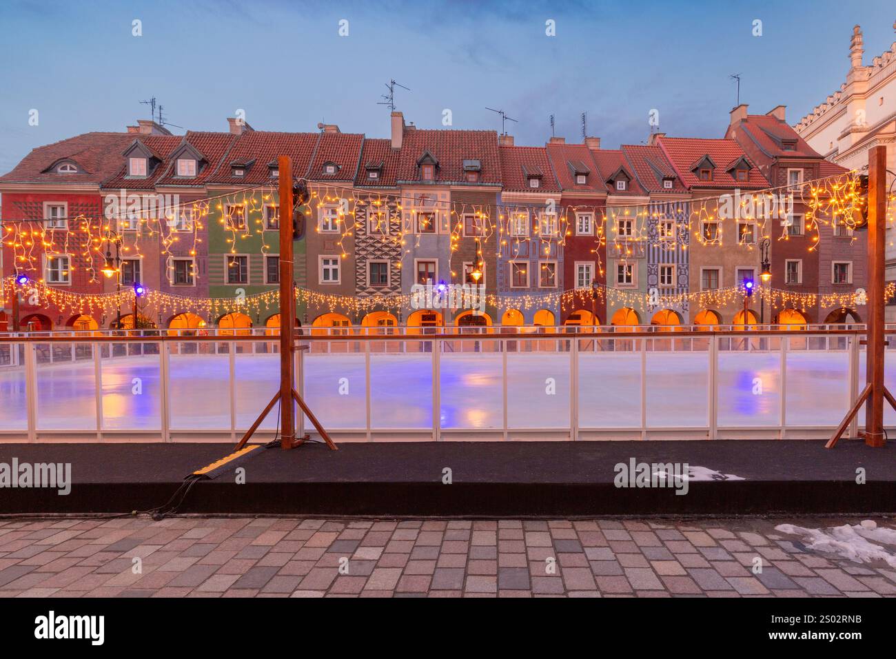 View of colorful facades of houses with illuminated arcades reflected ...