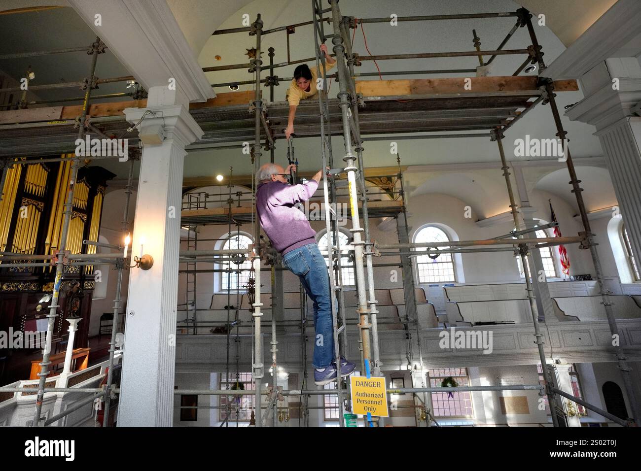 Conservator Corrine Long, of Dover, N.H., top, hands equipment to ...