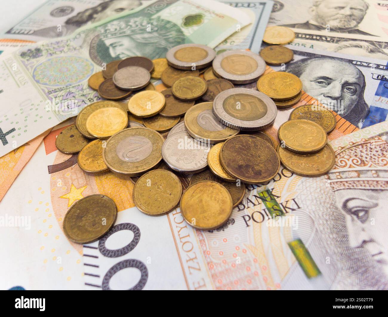 A pile of coins and bills including a 50 cent bill. The coins are of ...