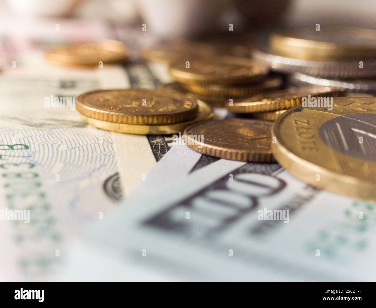 A pile of coins and a bill with the number 2 on it. The coins are of ...