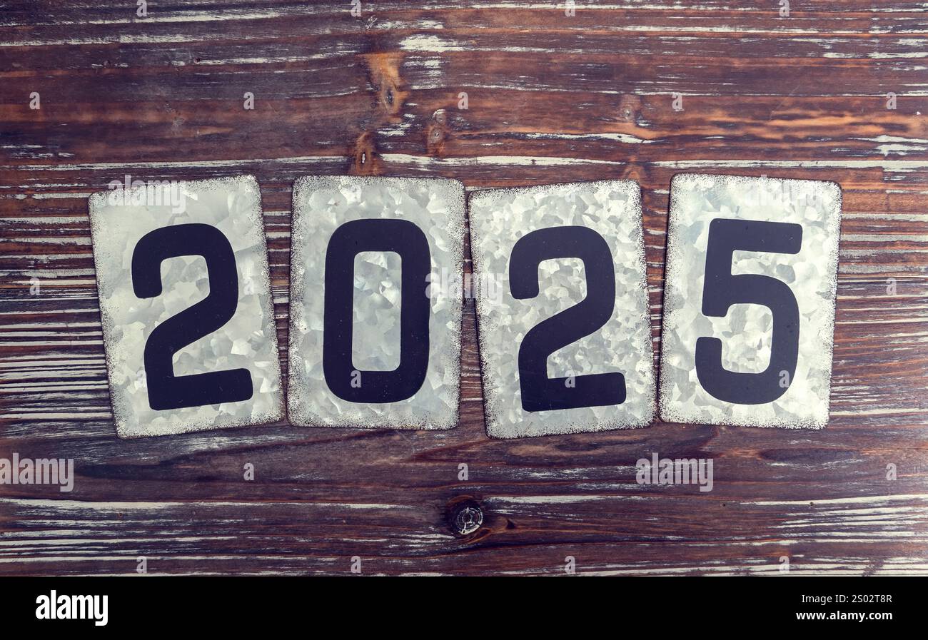 The metal year 2025 text on wooden card Stock Photo - Alamy