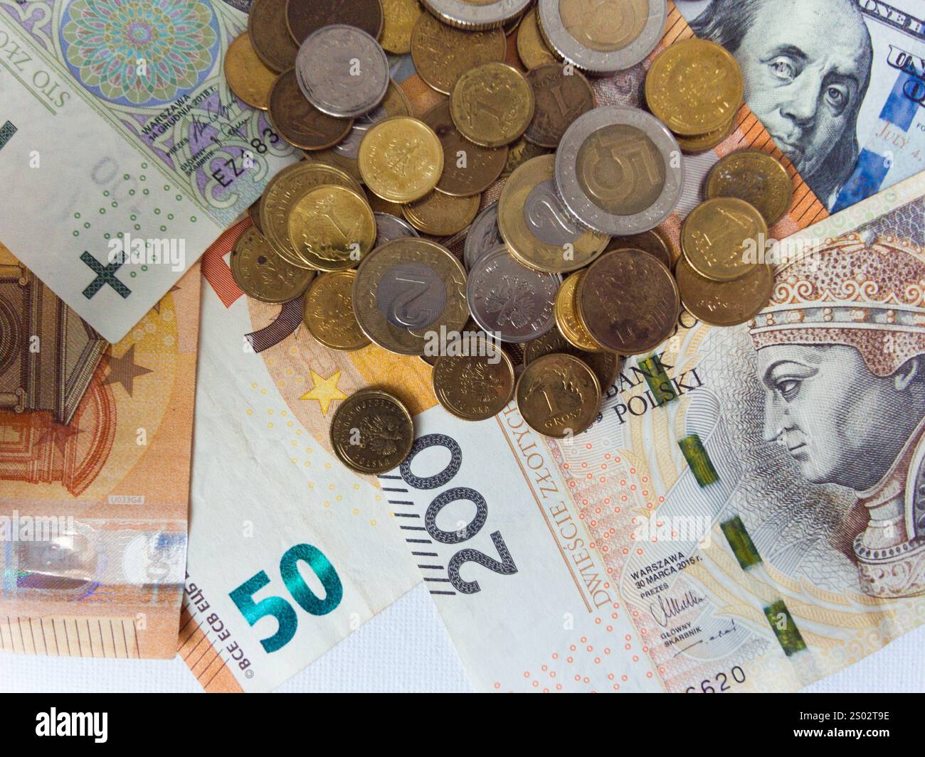 A pile of coins and bills including a 50 cent bill. The coins are of ...