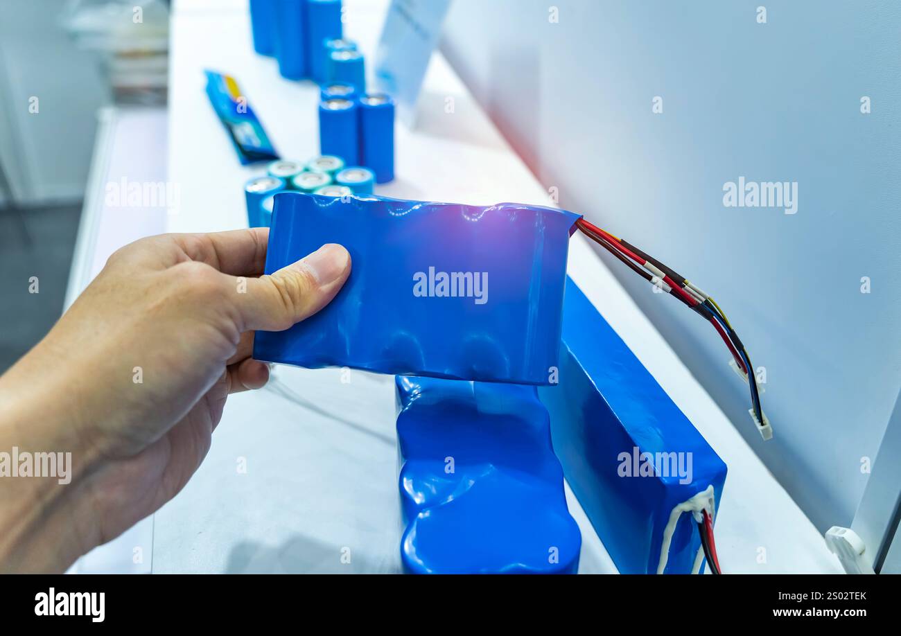 hand with Lithium ion industrial high current batteries and connector ...