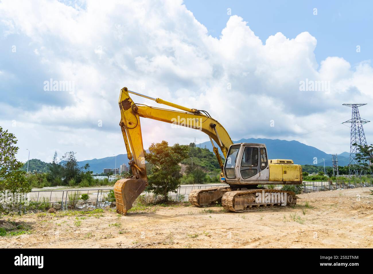 Heavy earth mover with blue sky in the background Stock Photo - Alamy