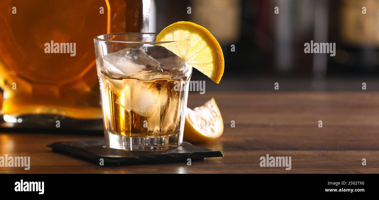 Glass of cold rum with lemon slice on table. Banner for design Stock ...