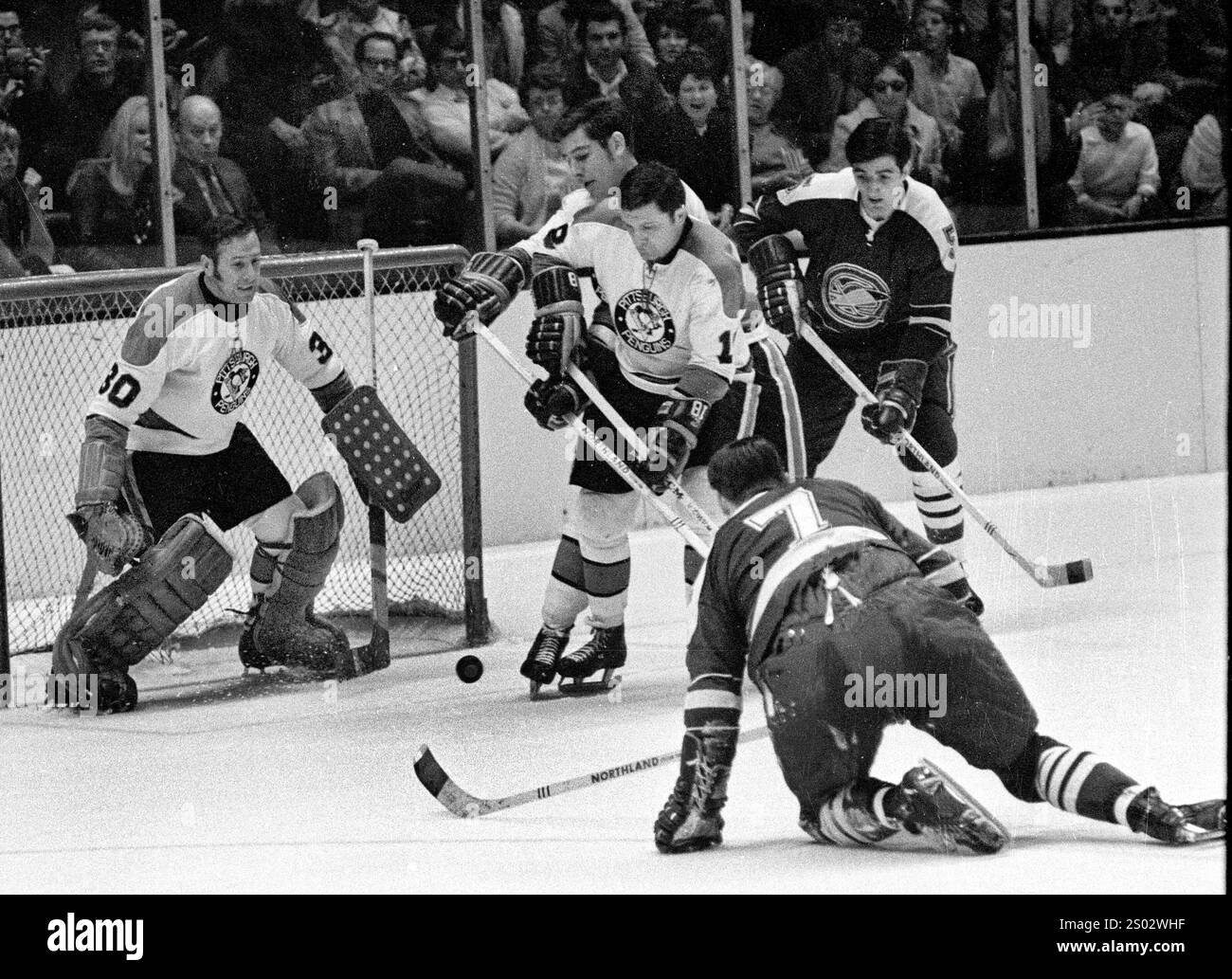 Pittsburgh Penguins goalie Les Binkley (30) with help from Wally Boyer ...