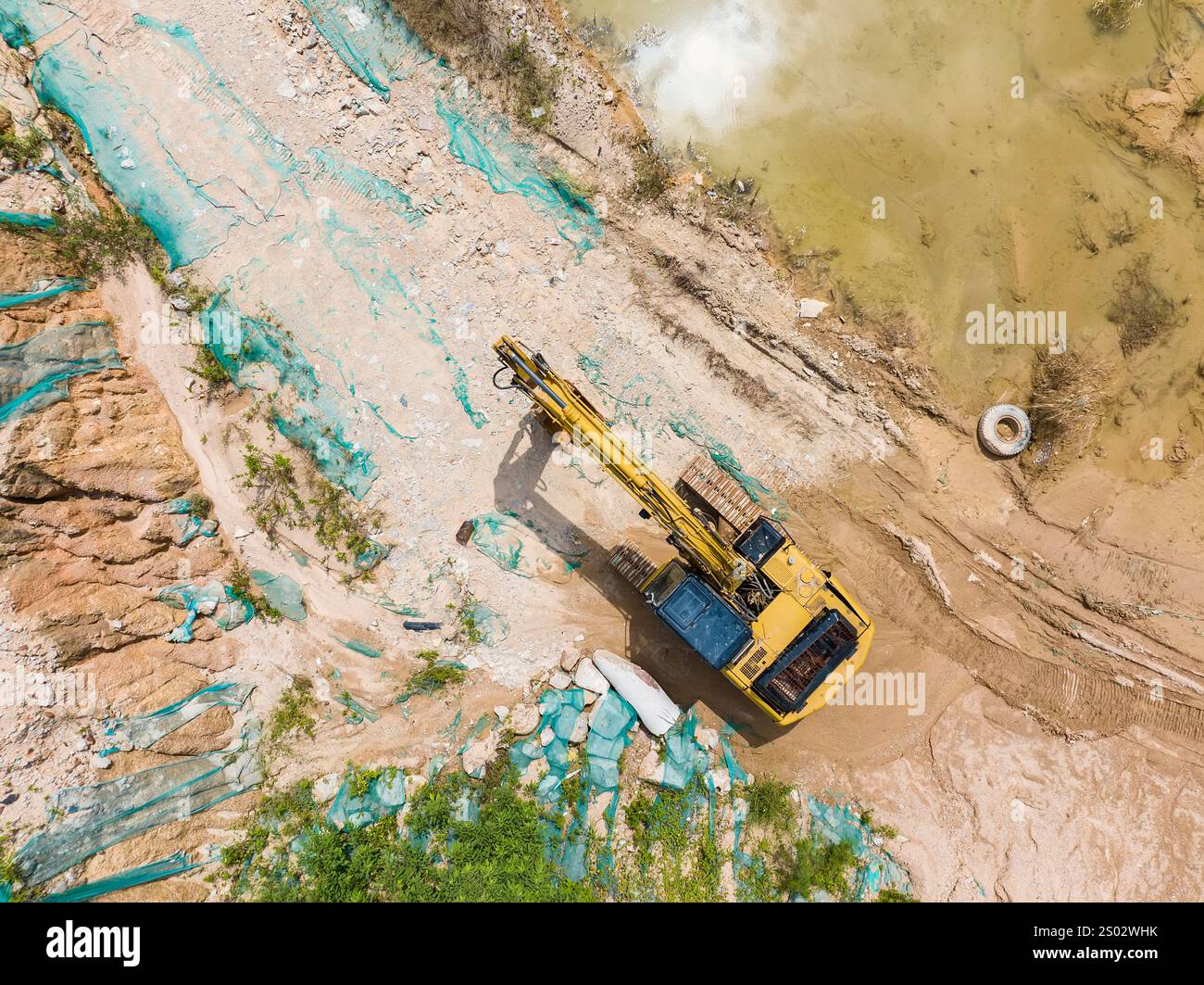 Excavator on earthmoving at construction site, aerial view Stock Photo ...