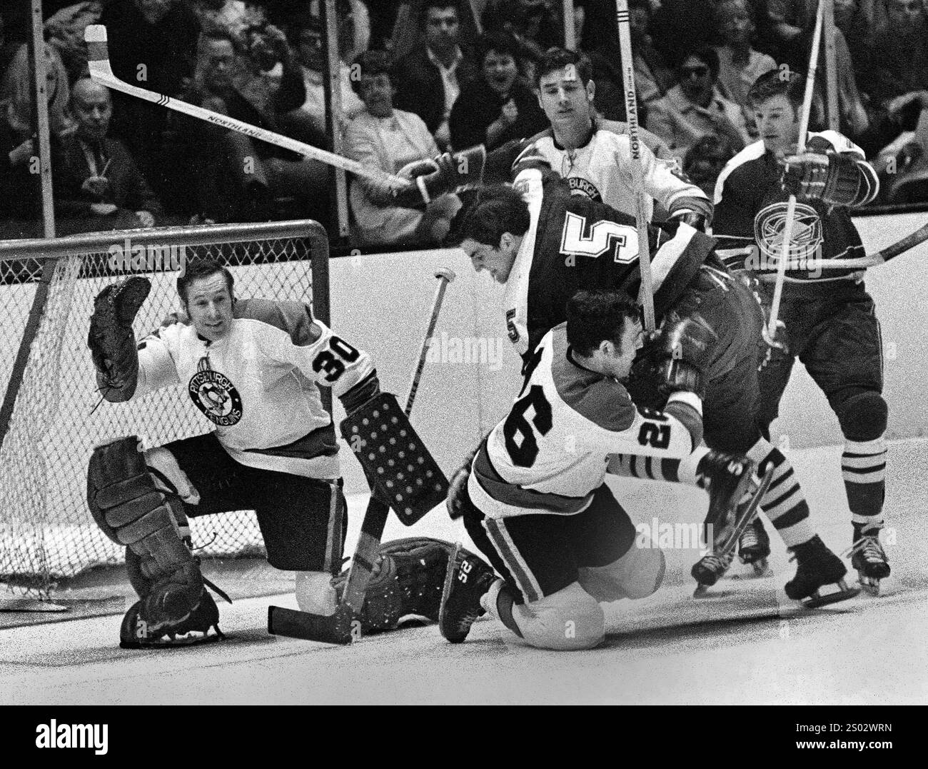 Pittsburgh Penguins goalie Les Binkley (30) with help from Syl Apps (26 ...