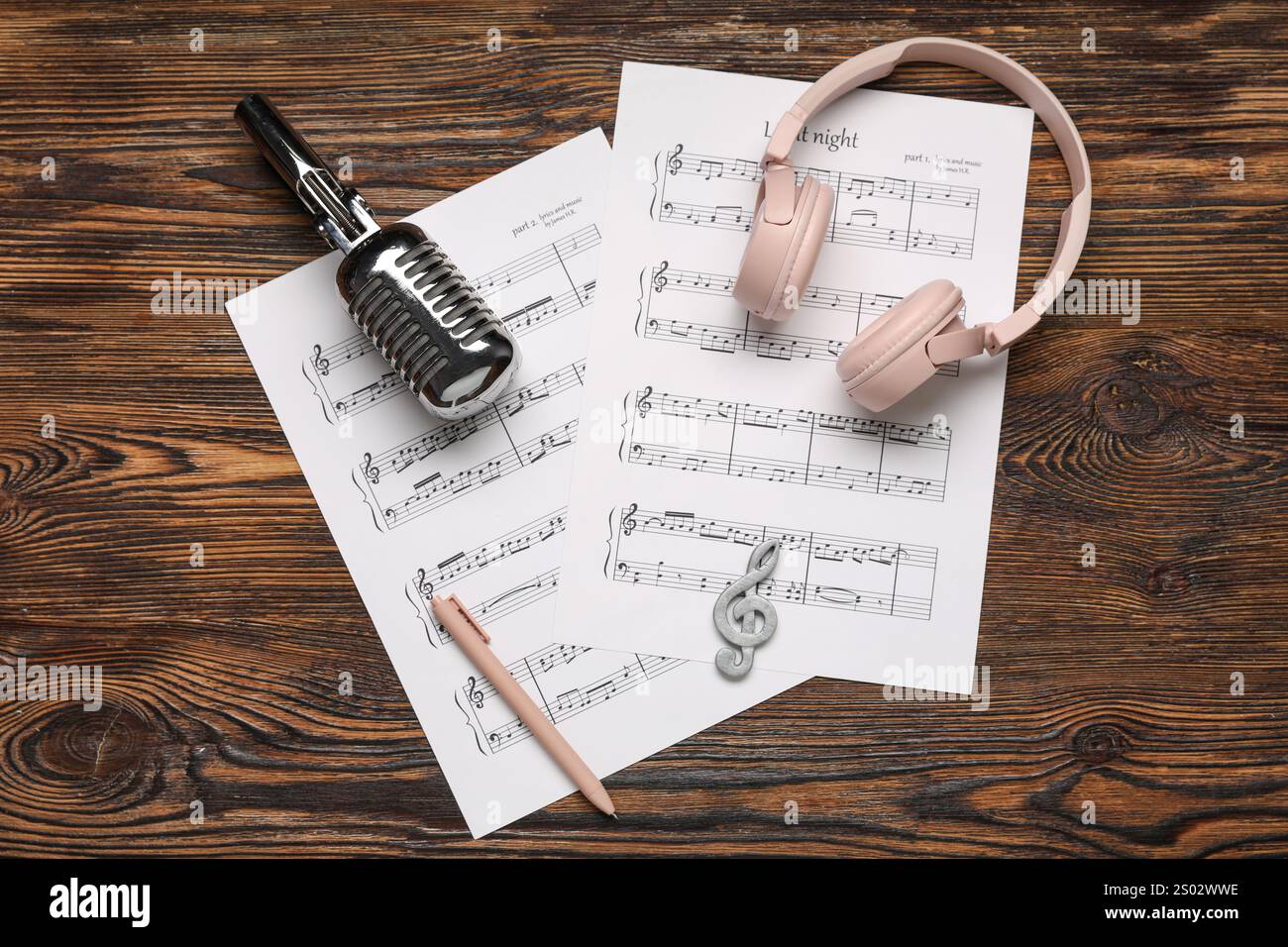 Music sheets with headphones and microphone on wooden background Stock ...
