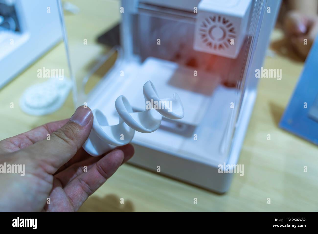 hand with spiral object printed on 3d printer close-up Stock Photo - Alamy