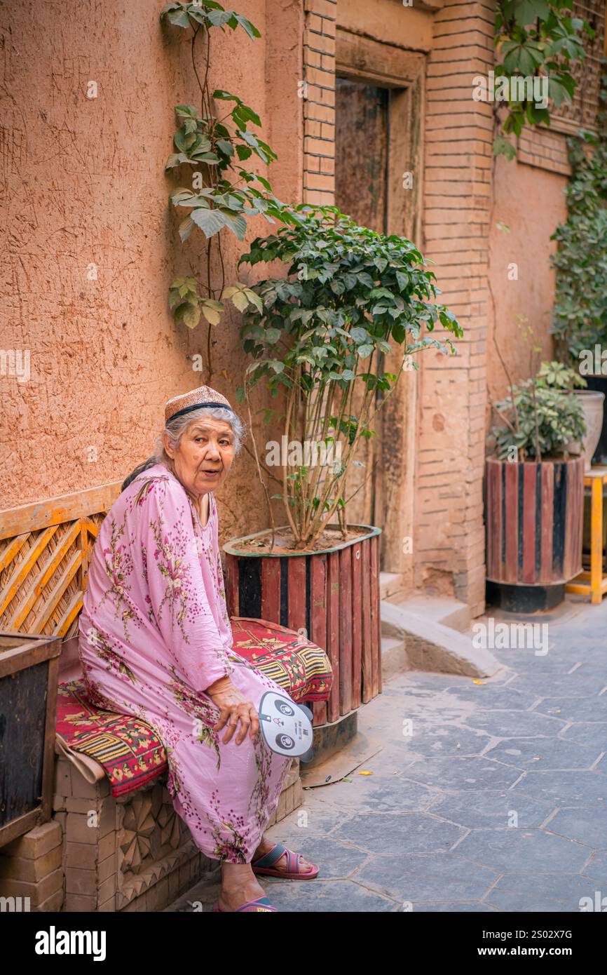 Kashgar, Xinjiang, China - JULY, 17, 2023: An old woman wearing Uighur ...