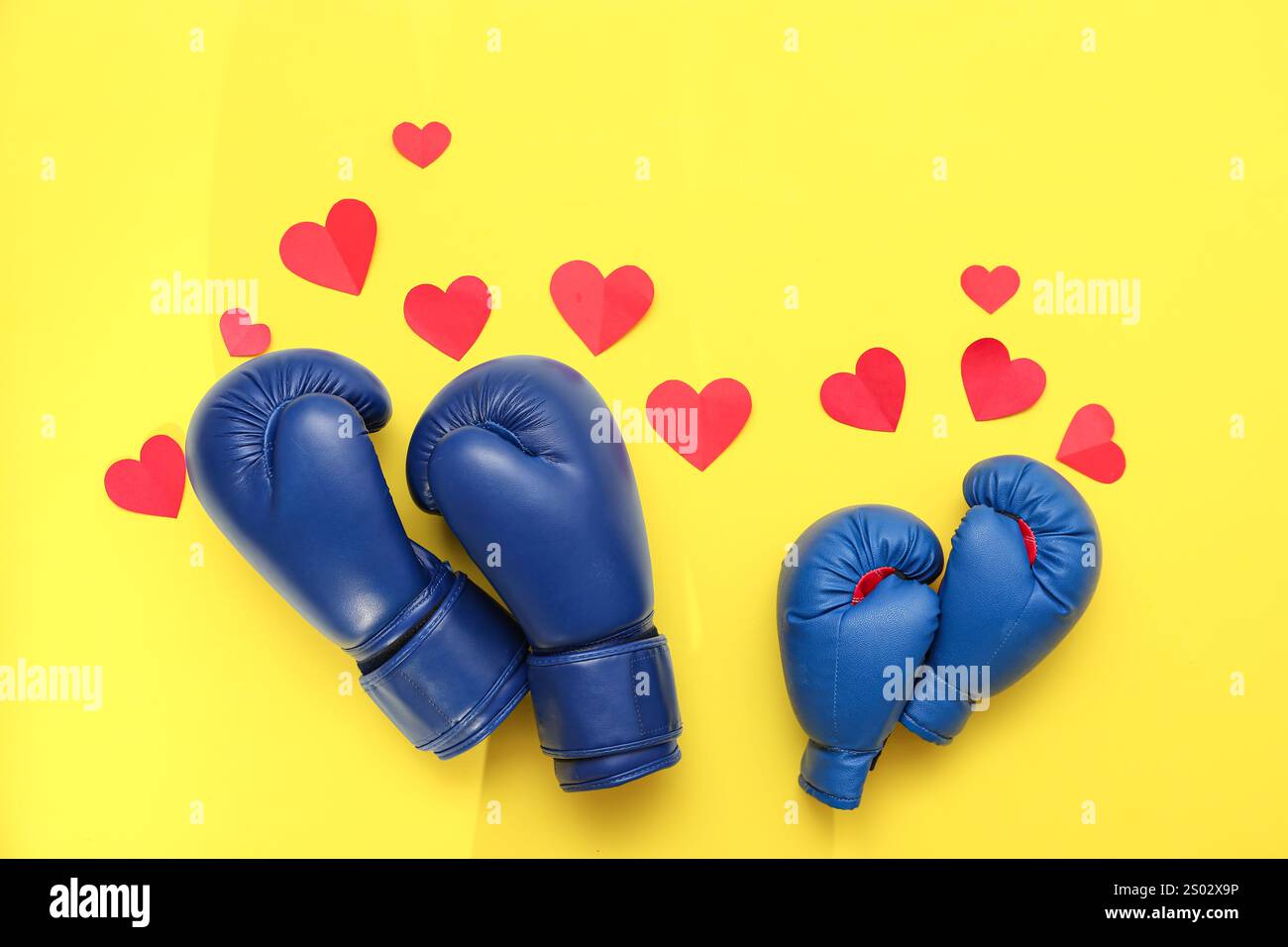 Composition with boxing gloves and red paper hearts on yellow ...