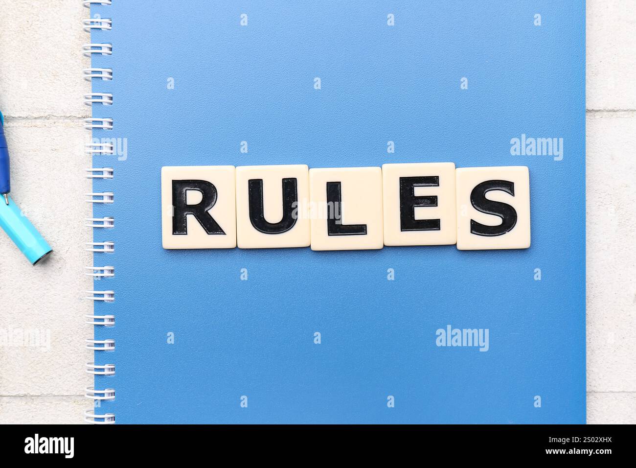 Notebook with word RULES on light tile background, closeup Stock Photo ...