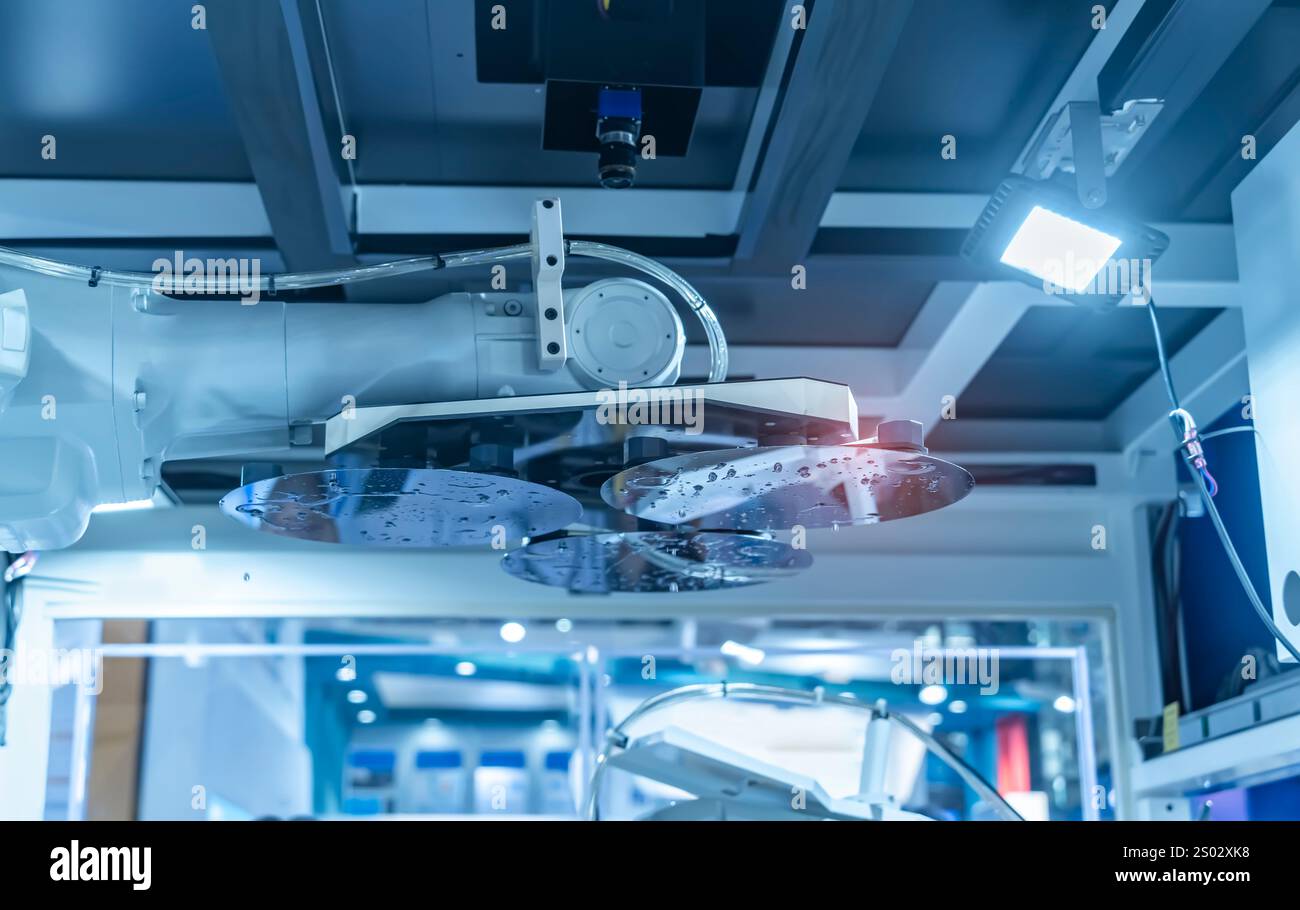 Silicon wafer extracted by Pick and Place automate robot arm Machine. Computer Chip ...
