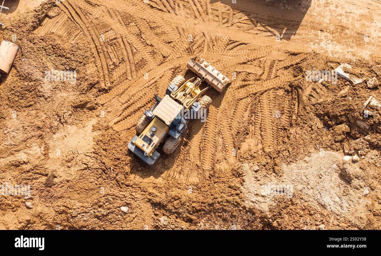 bulldozer on earthmoving at construction site, aerial view Stock Photo ...
