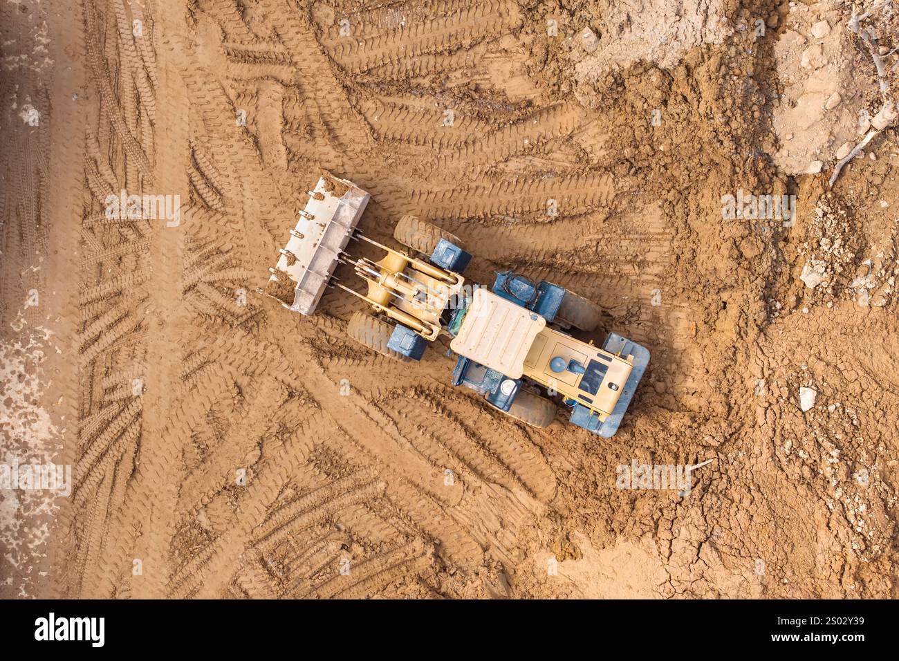 bulldozer on earthmoving at construction site, aerial view Stock Photo ...