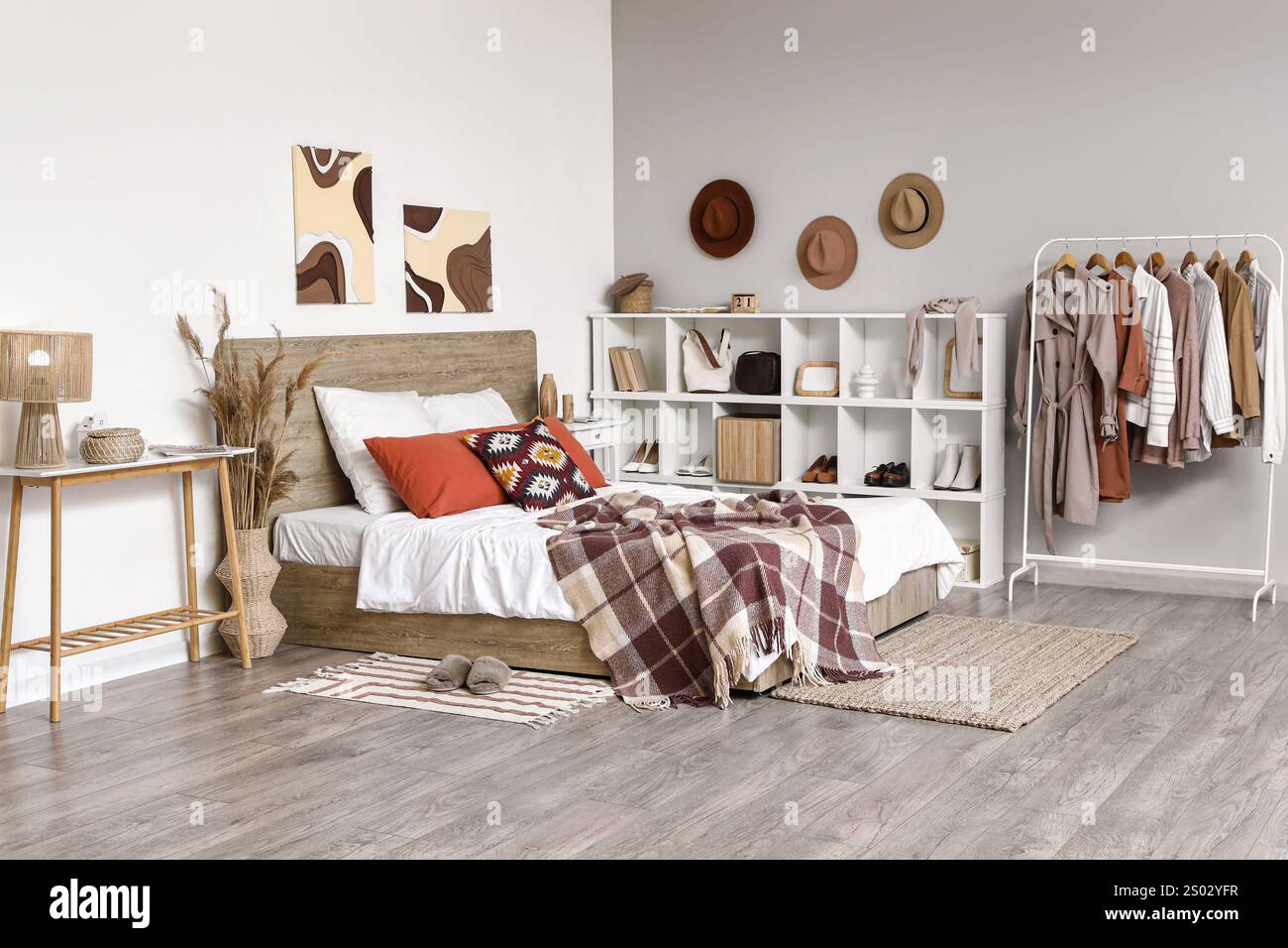 Stylish interior of modern bedroom with clothes rack Stock Photo - Alamy
