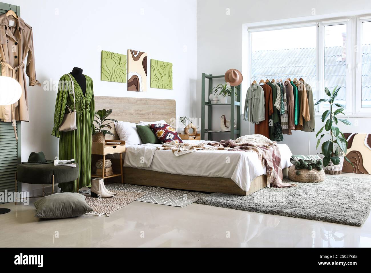 Interior of stylish bedroom with clothes rack and mannequin Stock Photo ...