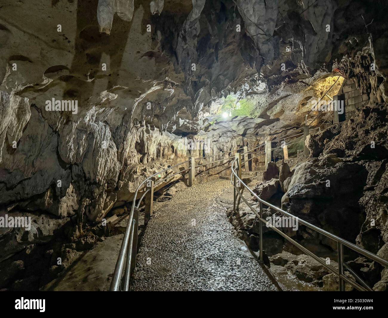 Pathway Through an Illuminated Cave Stock Photo - Alamy