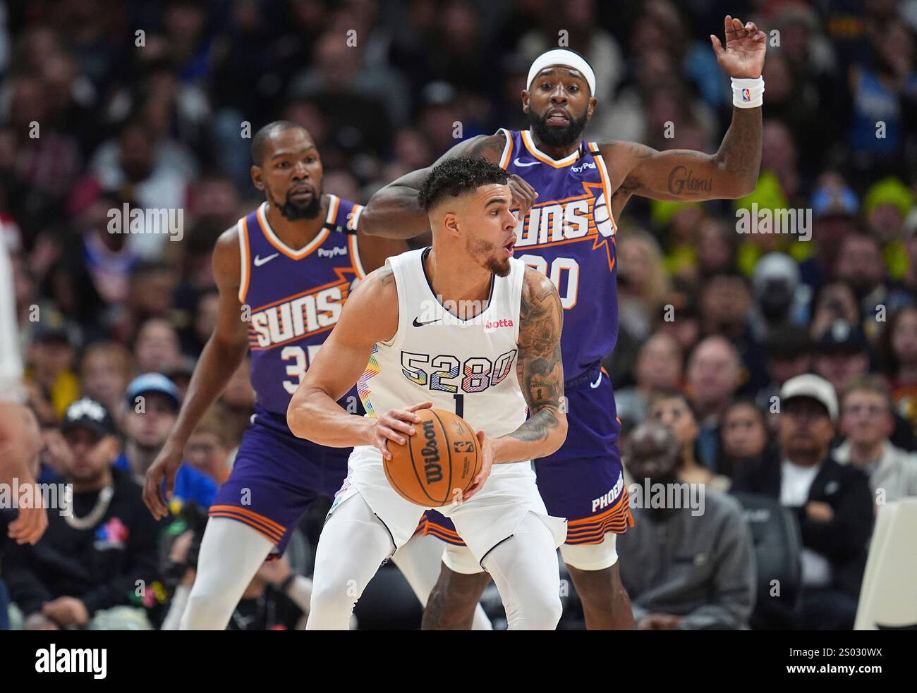 Denver Nuggets forward Michael Porter Jr., front, looks to pass the ...