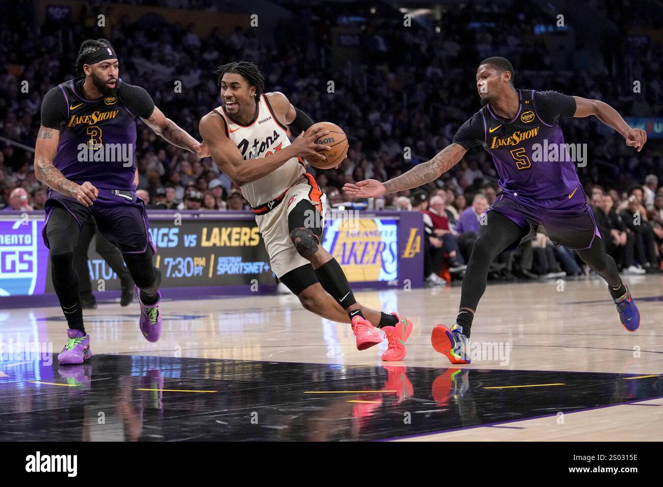 Detroit Pistons guard Jaden Ivey dribbles past Los Angeles Lakers ...