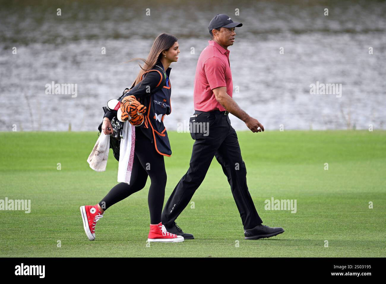 Tiger Woods, right, and his daughter Sam Woods walk on the 14th fairway ...