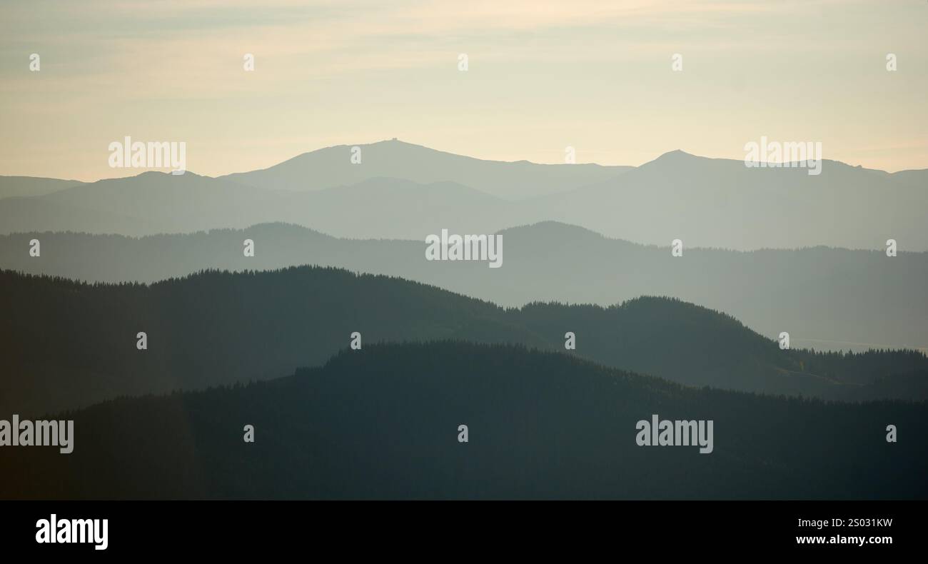 Mesmerizing view of layered mountain ranges in soft shades of green and ...