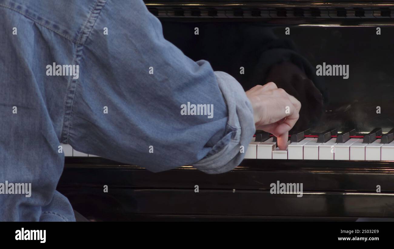 A talented pianist skillfully plays beautiful melodies on a grand piano ...