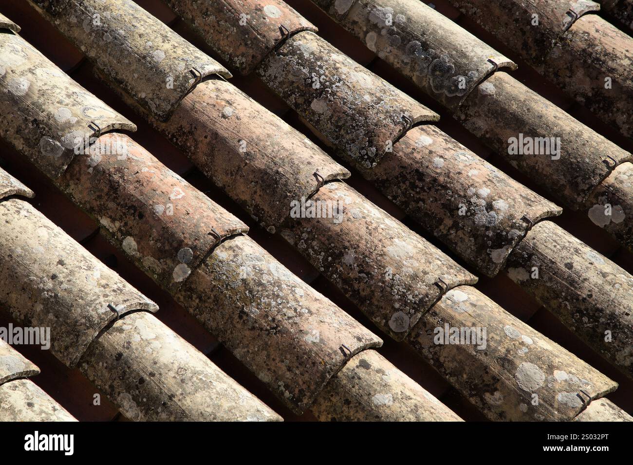 Old clay roof tiles display a unique arrangement and weathering effects ...
