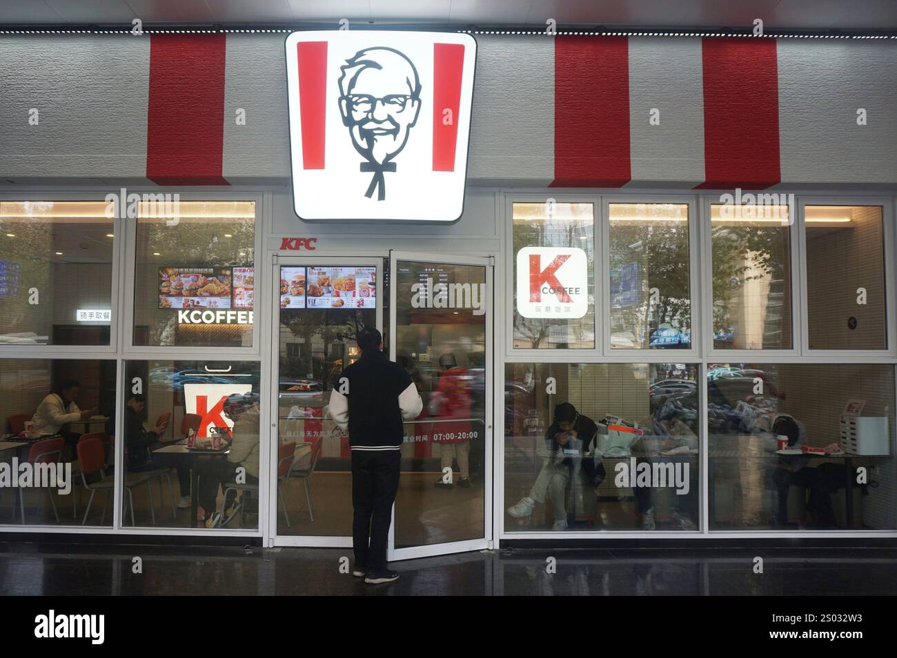 A man walks into a KFC outlet in Hangzhou in east China's Zhejiang ...
