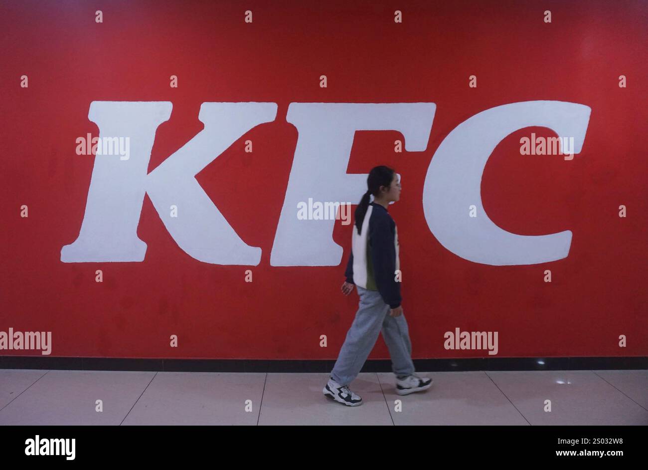 A girl walks by a KFC outlet in Hangzhou in east China's Zhejiang ...
