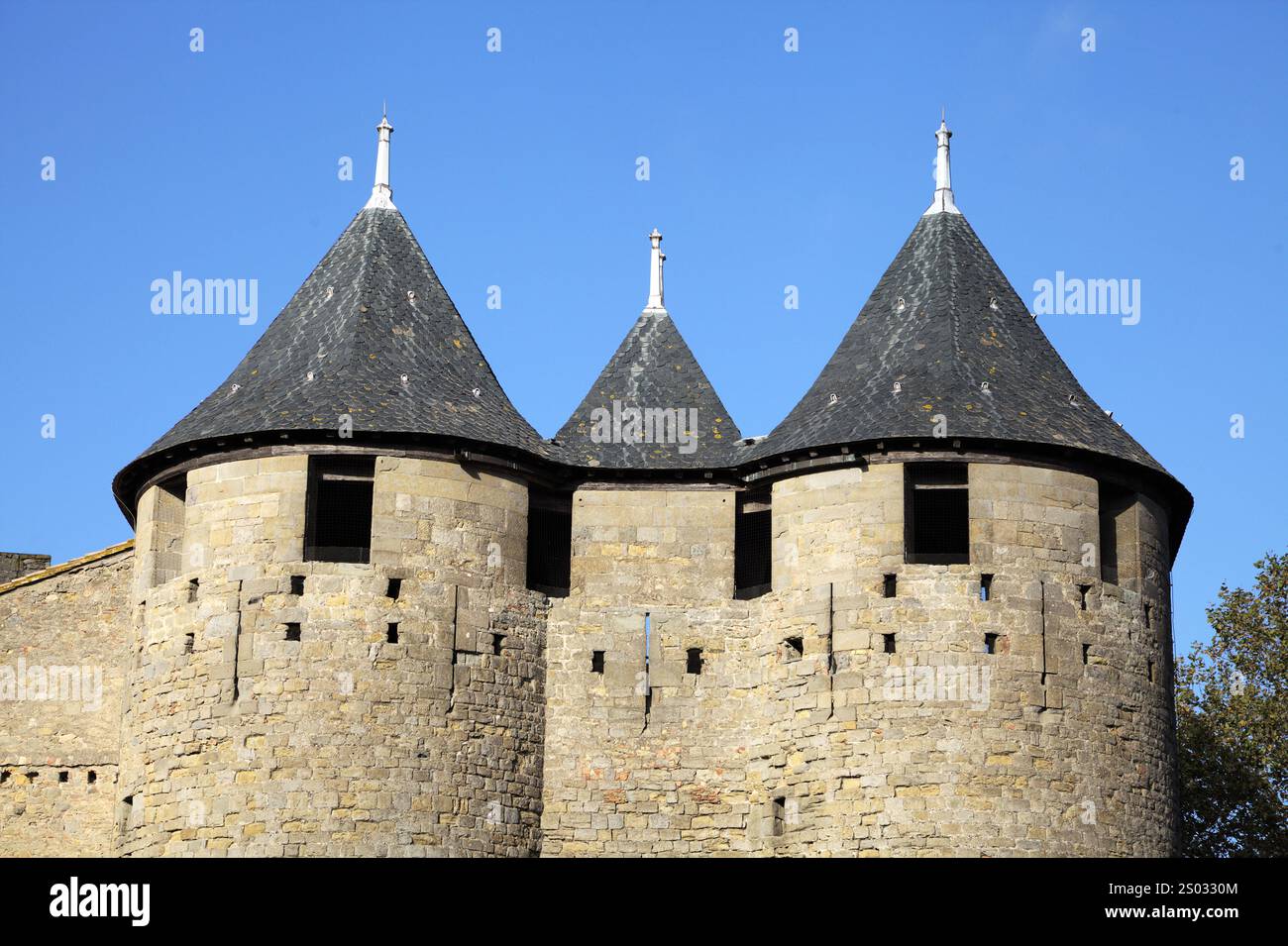 Visitors admire the impressive fortified walls and towers of ...