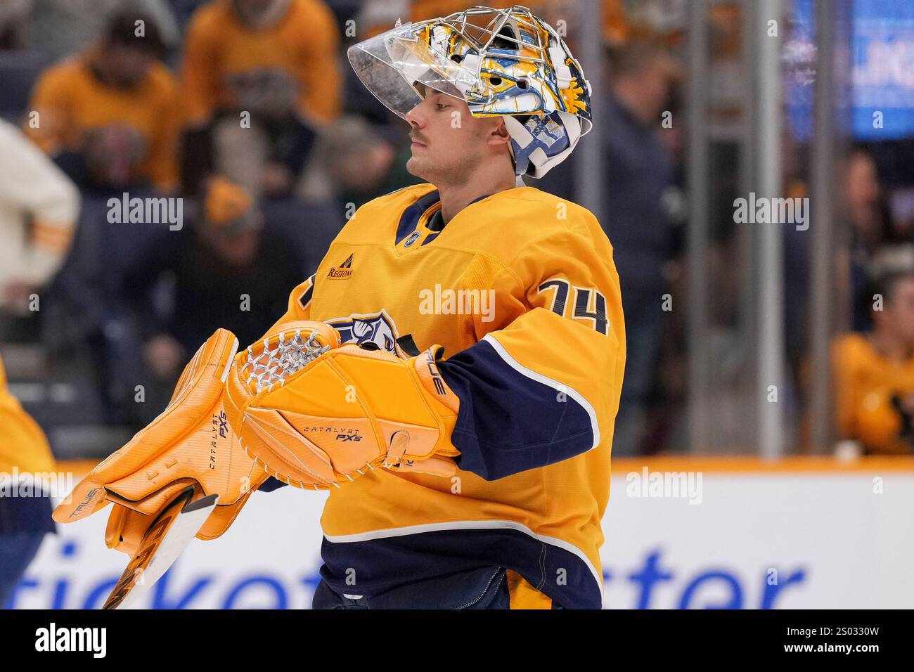 Nashville Predators goaltender Juuse Saros (74) warms up for the team's ...