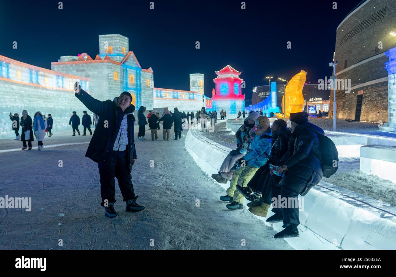 Tourists play at the Harbin Ice-Snow World in Harbin City, northeast ...