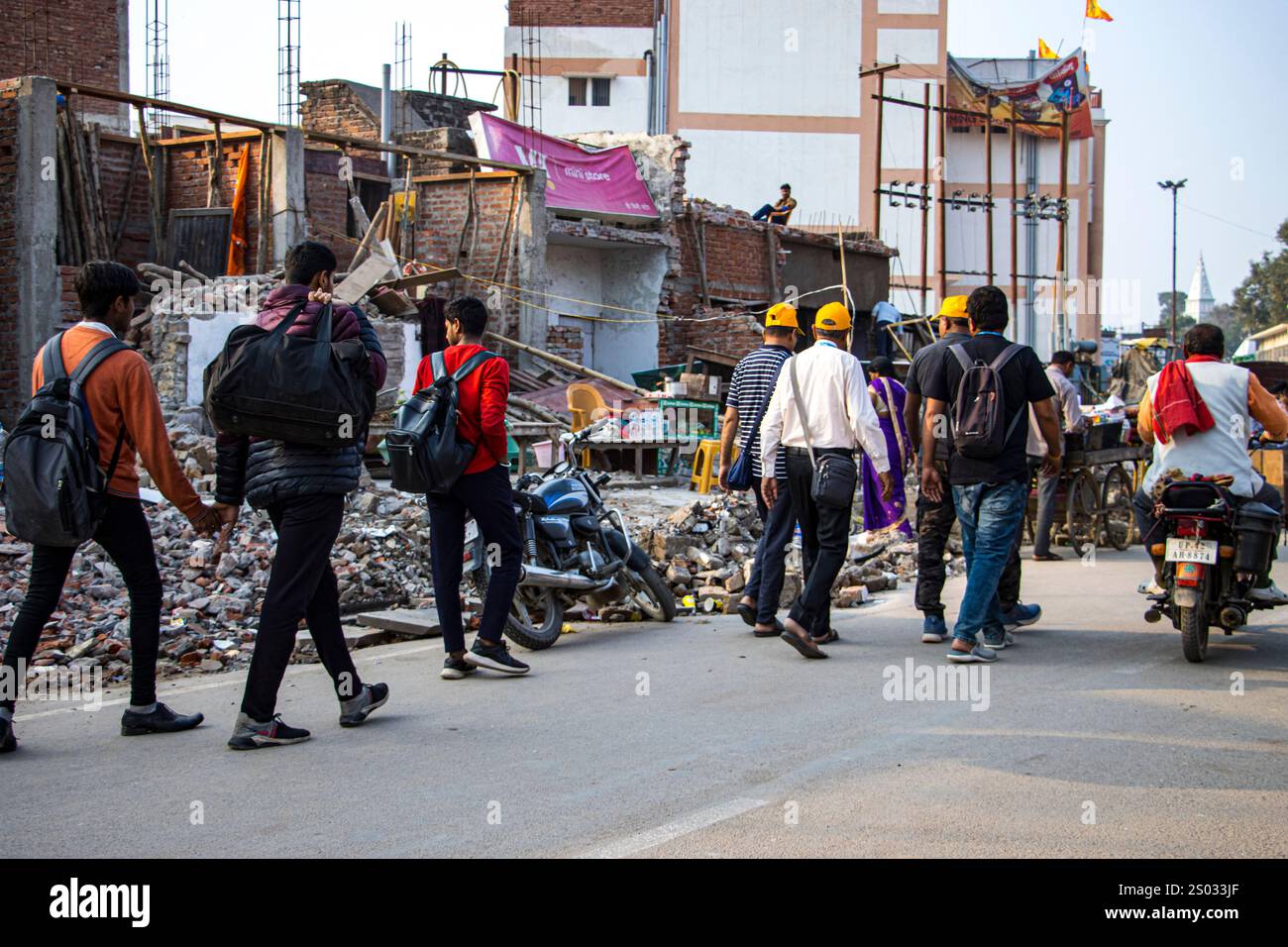 People arriving at Ayodhya Railway junction walk pass series of vendors ...
