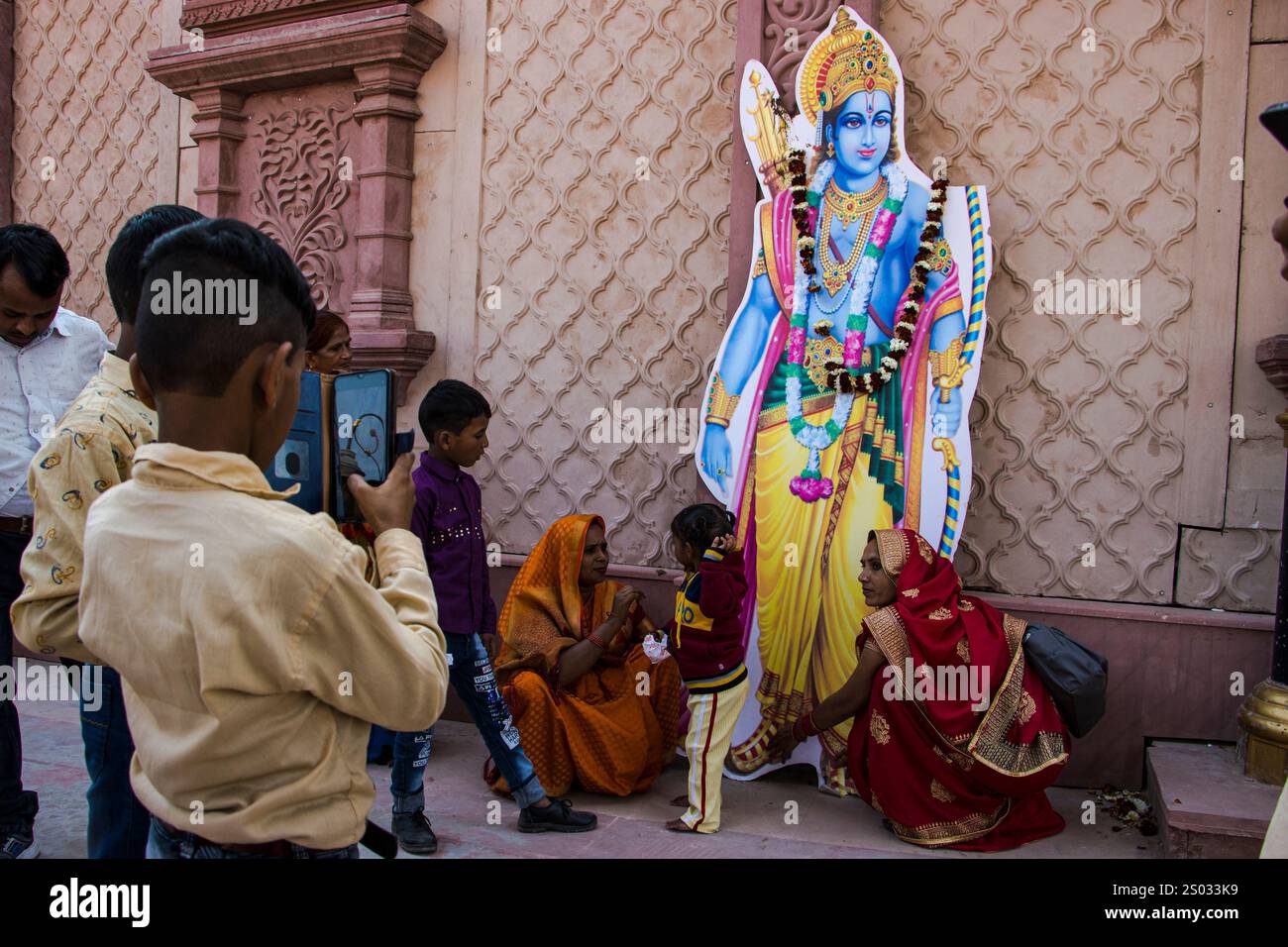 Pilgrims take photos with Lord Ram cut-out at the Ram Janmabhoomi ...