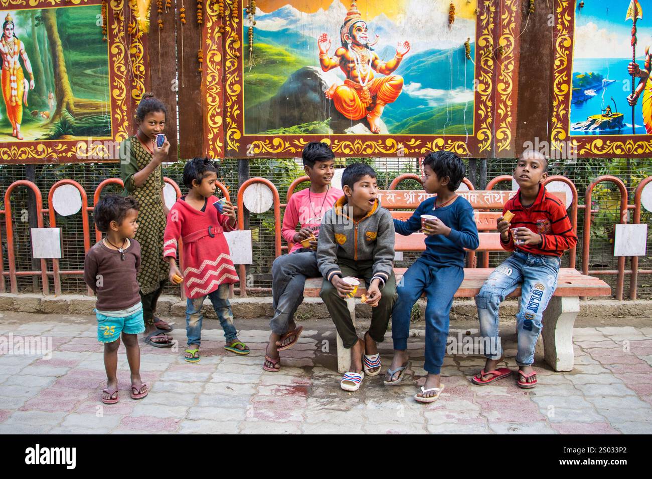 Children enjyoing halwa snack distributed by Varanasi temple associate ...