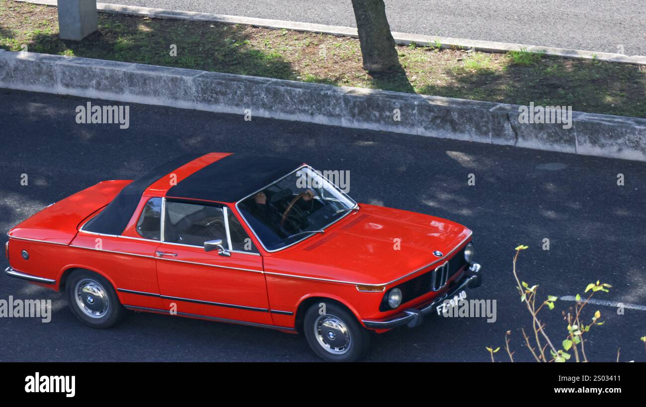 Classic red bmw 2002tii driving on an asphalt road Stock Photo - Alamy
