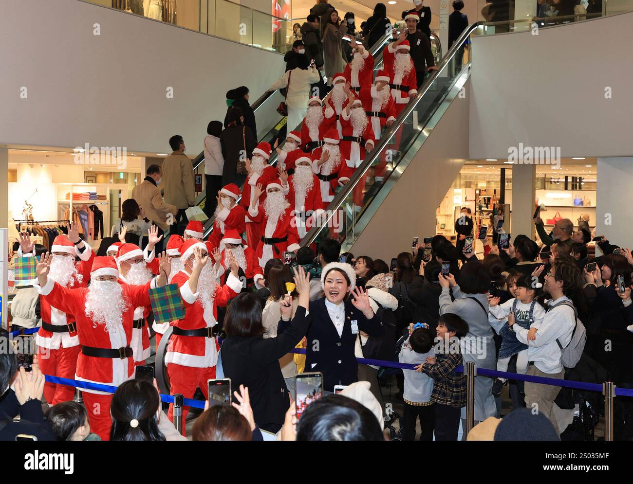 Santa Clauses ride on an escalator at a department store "JR Kyoto ...
