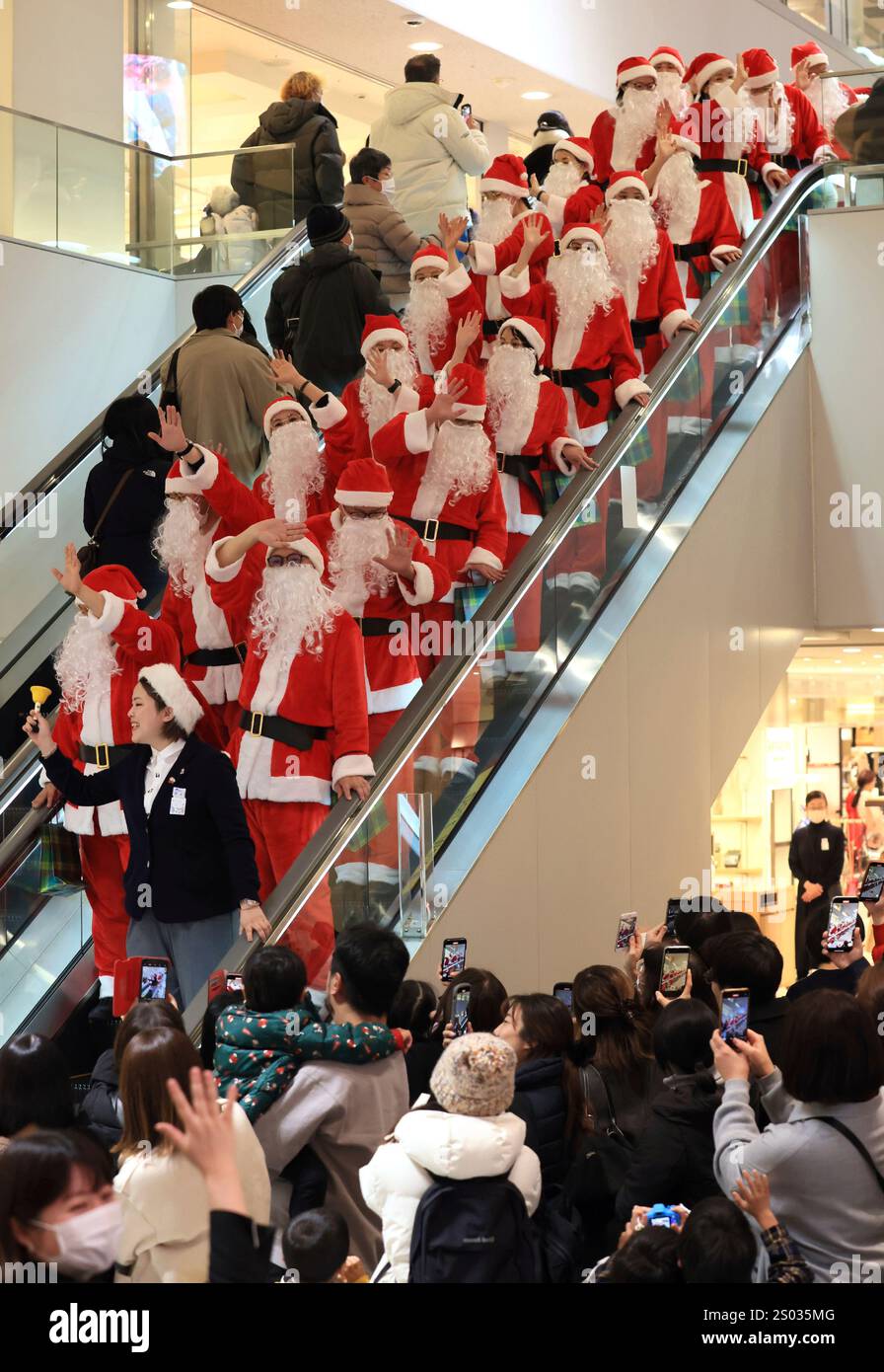 Santa Clauses ride on an escalator at a department store "JR Kyoto ...