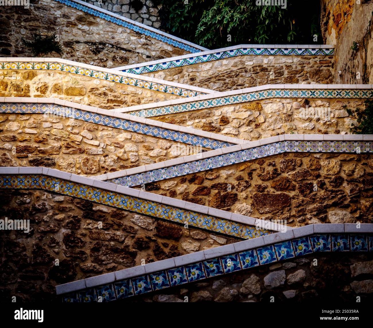 A series of stone steps with decorative tiles, showcasing a zigzag ...