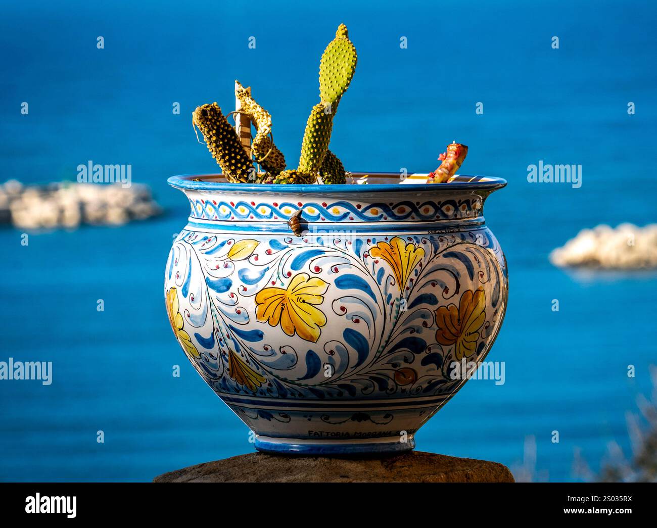A beautifully decorated ceramic pot with colorful floral patterns ...